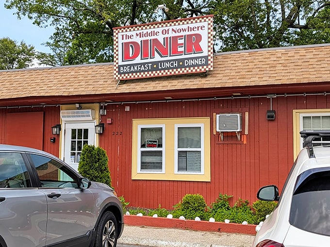 The Middle of Nowhere Diner proves the best discoveries happen off the beaten path. That red exterior and checkered sign beckon hungry travelers like a culinary lighthouse.
