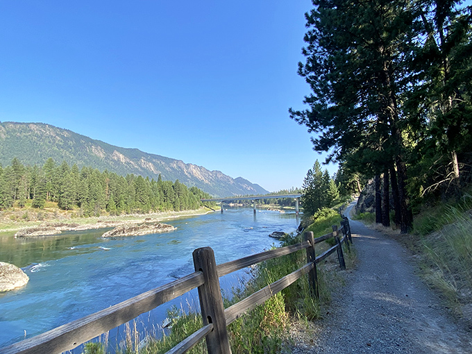 A riverside paradise awaits! Thompson Falls State Park's crystal-clear waters reflect the surrounding mountains like nature's own mirror.