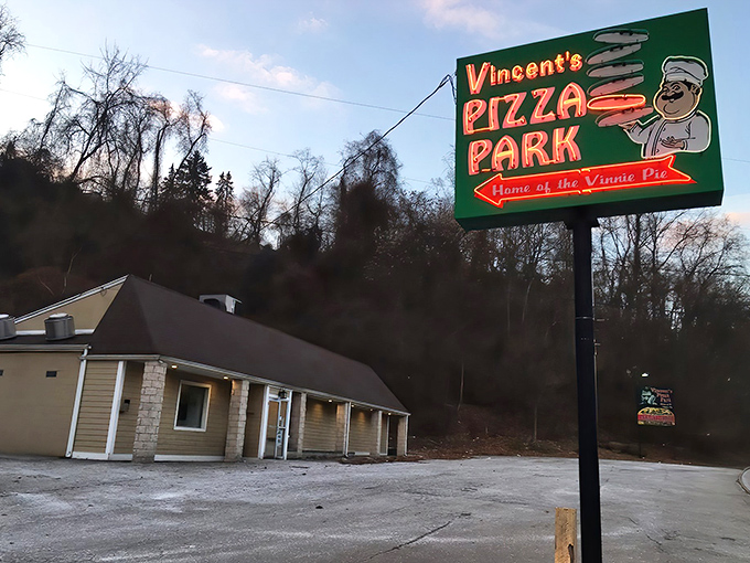 Vincent's Pizza Park sign glows like a beacon for hungry travelers. The "Home of the Vinnie Pie" promise isn't just words.