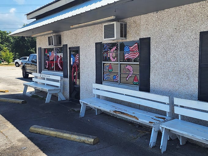 White benches outside a humble seafood joint&mdash;where the best conversations happen while waiting for your name to be called.