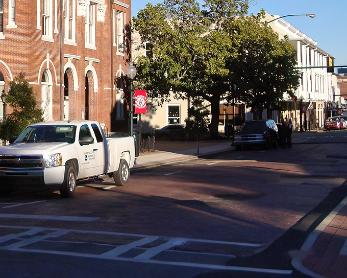 Experience the cozy, small-town charm of Bainbridge as golden hour light dances across the peaceful, tree-lined downtown city streets.