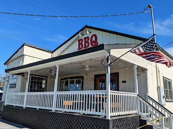 That covered porch whispers promises of pulled pork perfection and small-town hospitality at its finest. 