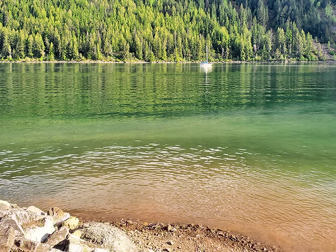 Emerald waters kiss the shoreline as mountains stand guard. This hidden gem makes you wonder why anyone vacations elsewhere.