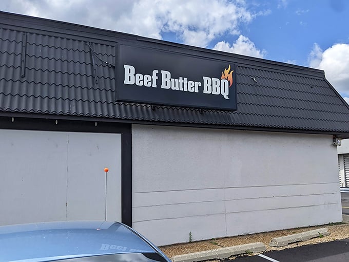 That sleek black sign against the white building is like a beacon calling all BBQ lovers home to brisket paradise.