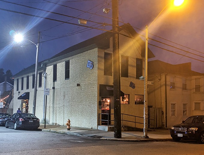 Night falls on Blue Pit BBQ, transforming this modest building into a beacon for smoke-seekers. The best treasures are often hidden in plain sight.