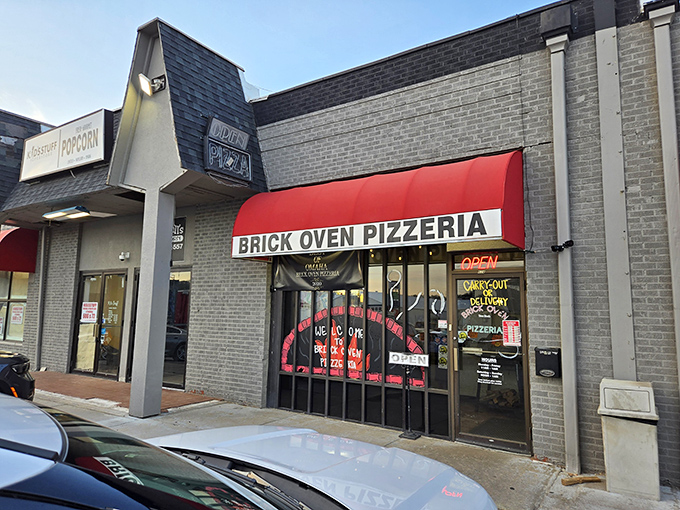 The red awning promises what awaits inside: authentic brick-oven pizza that would make any New Yorker do a double-take.