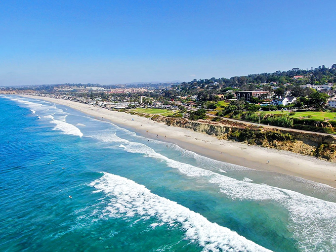 Where Del Mar's cliffs cradle the beach, creating nature's stadium for the daily sunset show.