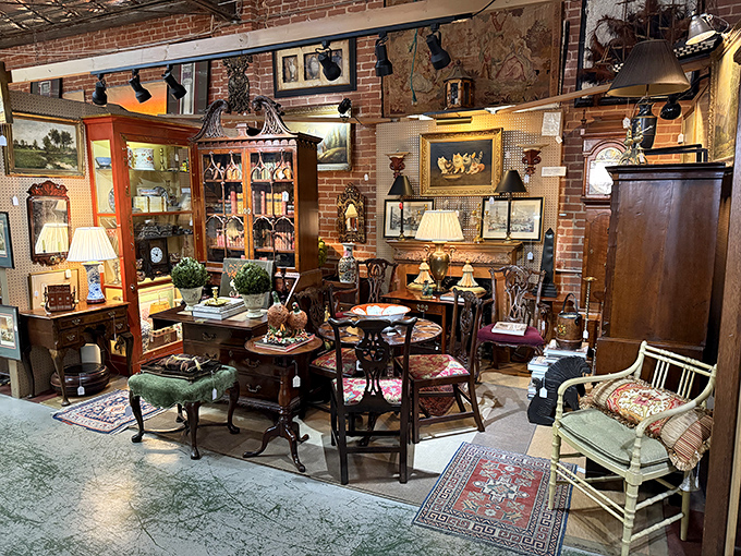 Inside Emporium Antiques, a beautifully arranged vendor booth showcases quality furniture, artwork, and decorative pieces at surprisingly reasonable prices.