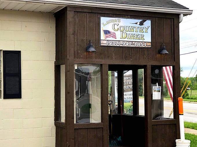 Laura's Country Diner entrance - The wooden entrance with American flag says it all&mdash;patriotism and comfort food, the twin pillars of small-town dining excellence.