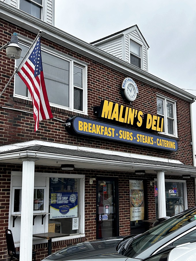 The American flag flies proudly outside Malin's, a patriotic guardian of proper deli traditions. This isn't just lunch&mdash;it's a delicious slice of Americana.