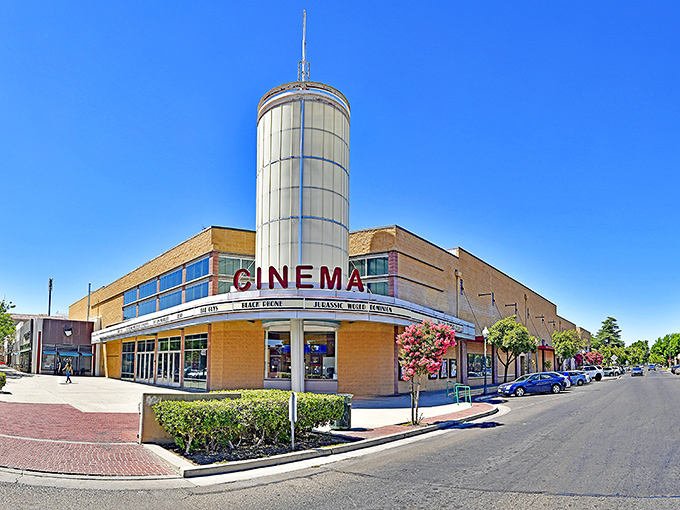 The Merced Theatre glows with art deco charm at dusk, its illuminated sign a beacon for entertainment seekers in the Central Valley.