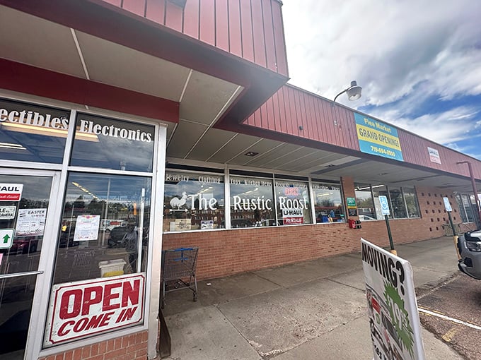 The welcoming entrance to PBNJ's features clear signage, organized sections for collectibles and electronics, and an inviting "OPEN COME IN" message for shoppers.