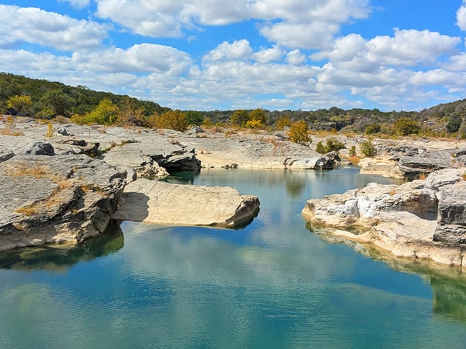 Smooth rock formations shaped by centuries of flowing water, like Mother Nature's own infinity pool.