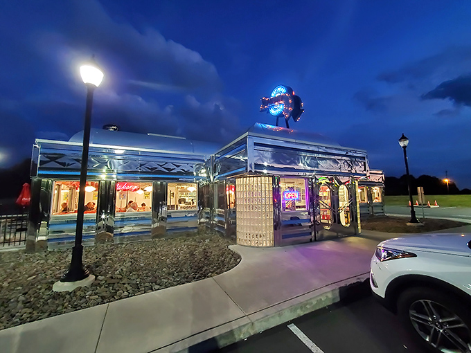 By night, the neon glow transforms this chrome beauty into a beacon for night owls and early birds alike.