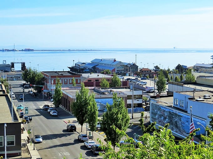 Port Angeles downtown meets waterfront—where small businesses thrive and the distant water shimmers like nature's own mood lighting.