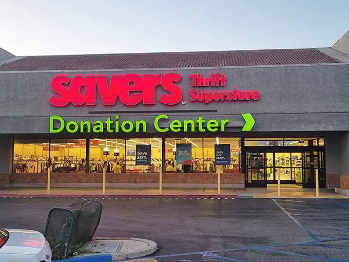 Savers glows in the evening light, its vibrant signage a beacon for bargain hunters. Tomorrow's vintage finds are today's donations.