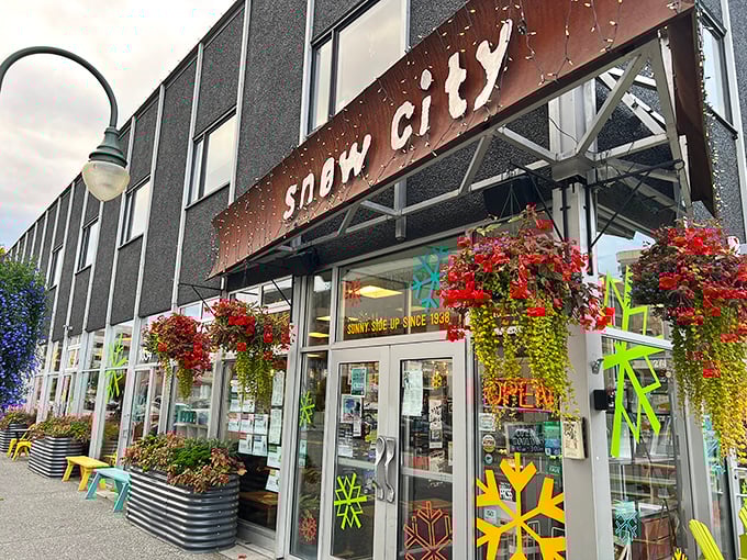Colorful flower baskets frame Snow City Cafe's entrance &ndash; a cheerful hint at the vibrant flavors waiting inside this beloved Anchorage institution.