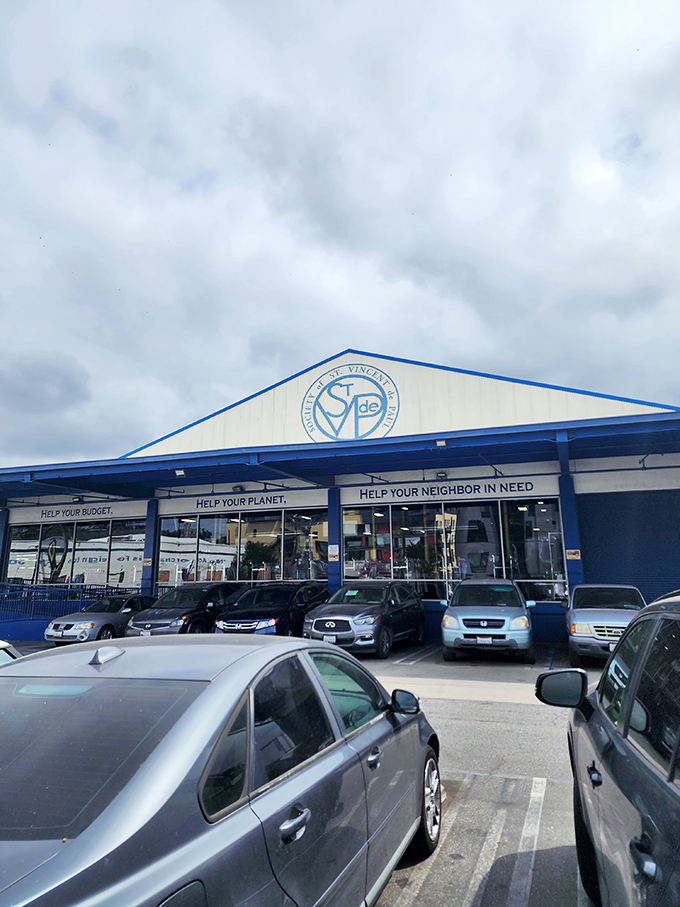 Under moody skies, St. Vincent de Paul stands like a cathedral of thrift. Those blue-trimmed windows showcase treasures waiting to be discovered.