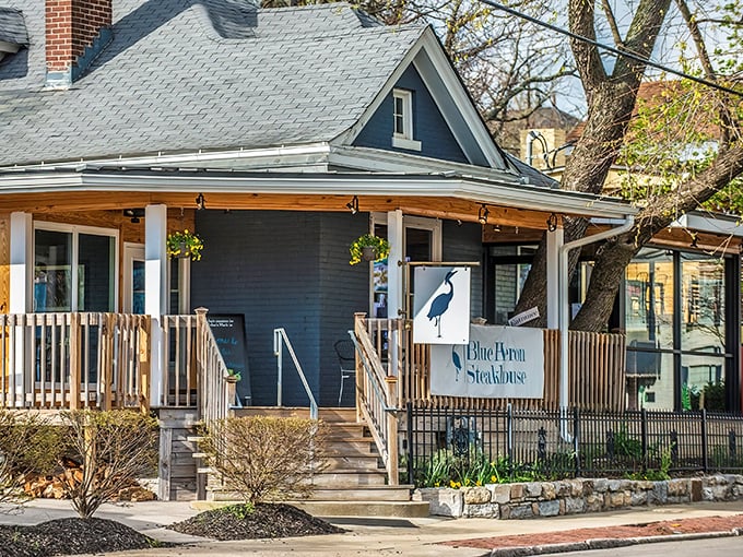 This cozy blue house transforms into steak paradise after dark. The porch practically whispers, "Come on in, y'all."