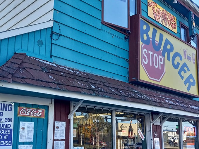 The bright yellow "BURGER STOP" sign is like a bat signal for hungry Alaskans seeking salvation between two buns.
