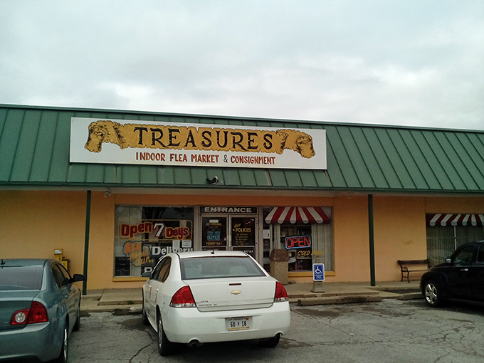 The yellow facade of Treasures Indoor Flea Market beckons with promises of hidden gems and bargain hunting adventures behind those doors.
