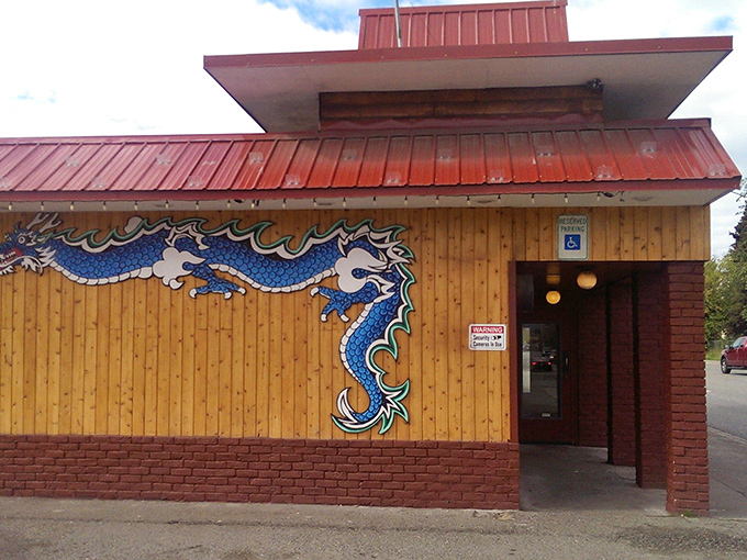 The intricate dragon artwork wrapping around this building hints at the fiery flavor adventure waiting inside for hungry guests.