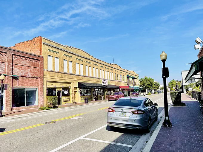 Historic buildings frame Wauchula's walkable downtown where local businesses thrive. The yellow facade adds a splash of sunshine to this quiet streetscape.