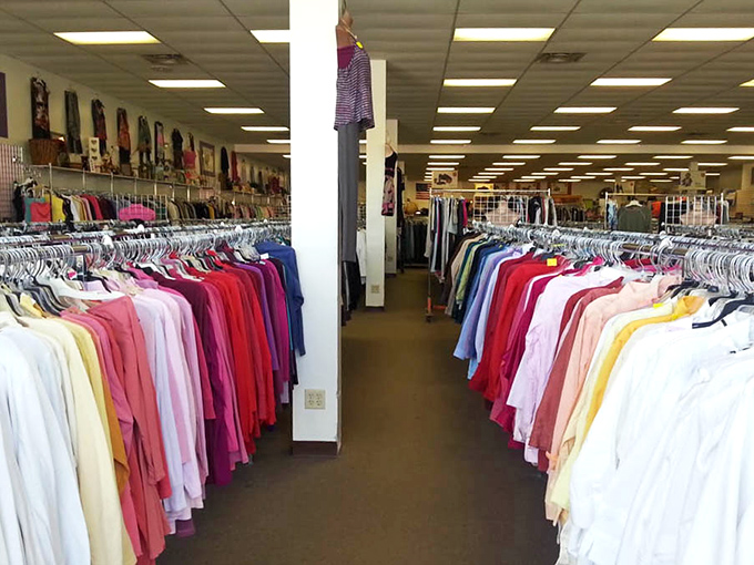 Rainbow rivers of clothing flow through the store, organized by color and size for the serious thrift explorer.