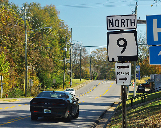 Highway 9 stretches ahead like an invitation to adventure, with church parking conveniently marked for Sunday morning salvation seekers.