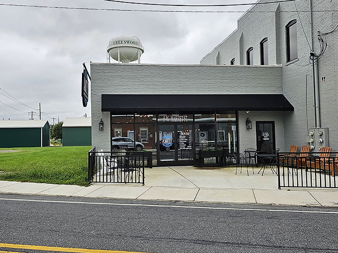 The iconic Greenwood water tower stands sentinel over this establishment, a beacon for locals seeking both refreshment and community connection.