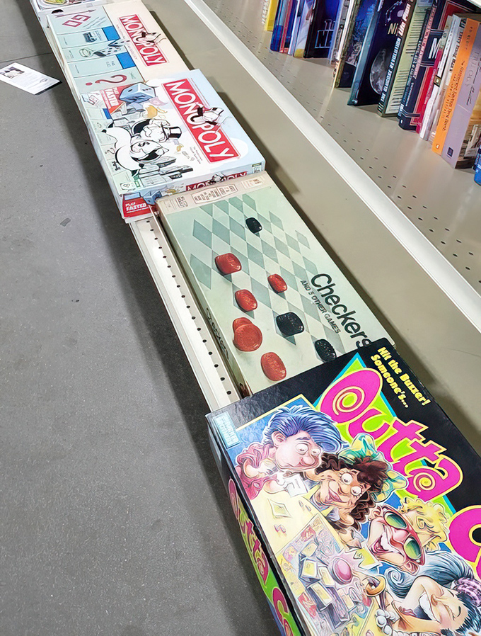 Board games and nostalgia, neatly lined up and waiting for a second chance. That Monopoly set might be missing the thimble, but the memories are fully intact.