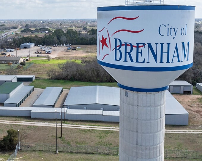 The iconic Brenham water tower stands sentinel over the landscape, a beacon announcing "yes, we have both water AND charm here."