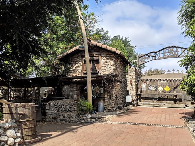 The grand entrance to Rubel Castle beckons with its stone guardhouse and ornate metal gate &ndash; medieval fantasy meets California sunshine in this handcrafted wonderland.