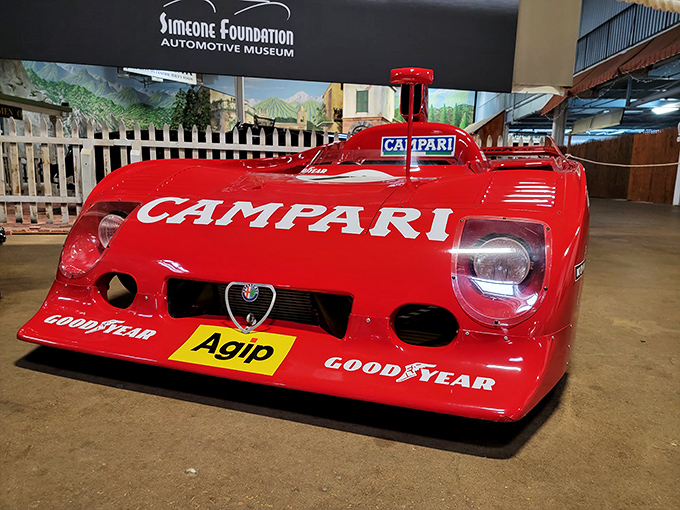 The Campari-sponsored Alfa Romeo race car looks like it's breaking the sound barrier while standing perfectly still. Italian engineering at its most flamboyantly red.
