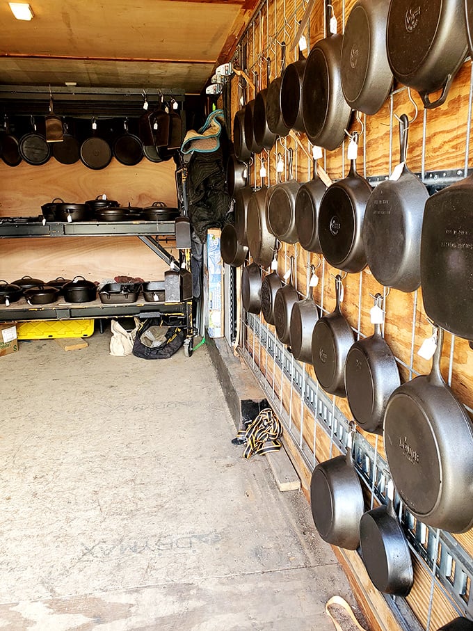 Cast iron paradise! This wall of perfectly seasoned skillets and Dutch ovens would make your grandmother weep with joy.