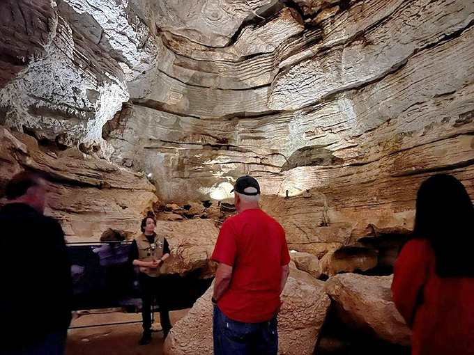 Nature's cathedral puts human architecture to shame. Visitors gaze upward at millions of years of geological artistry illuminated by strategic lighting.