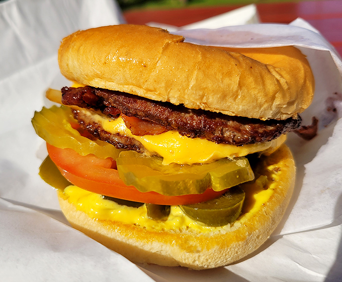 Architecture in its purest form&mdash;layers of beef, cheese, fresh veggies, and pickle slices creating a masterpiece that belongs in the Burger Hall of Fame. 