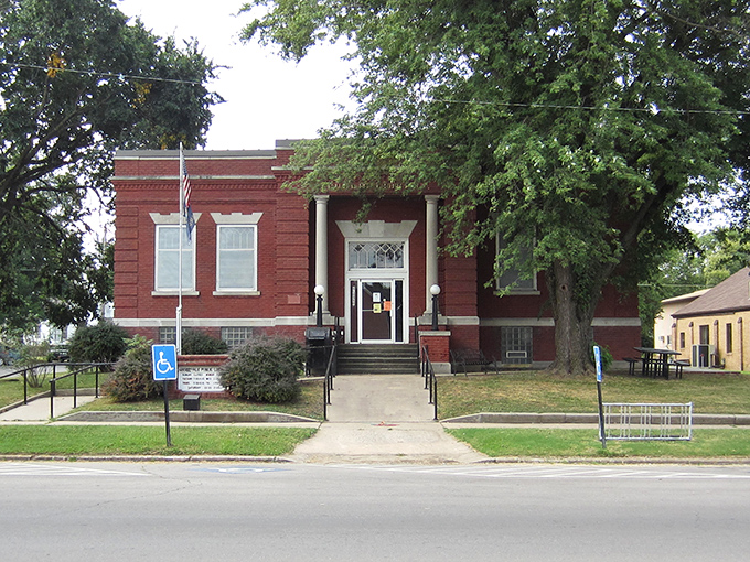 Carnegie's legacy lives on in this stately red brick library, where books and community have found a dignified home since the early 1900s.