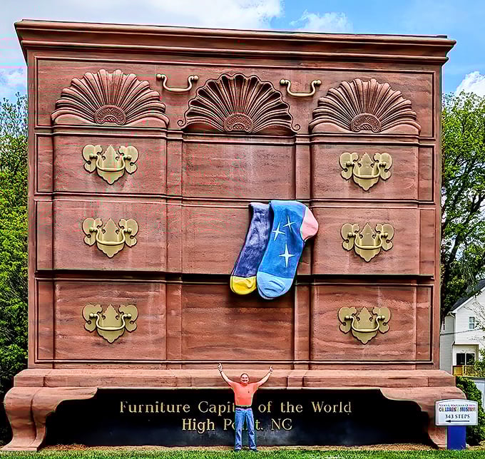 Those ornate fan carvings and golden drawer pulls aren't just for show—they're a nod to High Point's craftsmanship tradition. Furniture design on a truly grand scale!