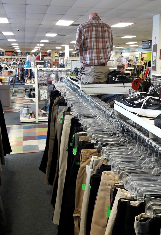 The pants section stretches into infinity. Each hanger holds not just clothing, but potential new identities waiting for the right person.