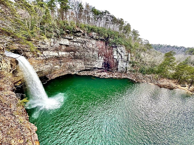 Mother Nature showing off again! This emerald pool beneath the waterfall looks like something straight out of a fantasy novel.