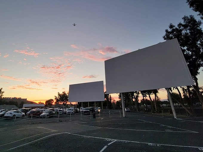 That magical moment when day surrenders to night, screens stand ready, and moviegoers settle in for Hollywood's latest offerings against a canvas of California sunset.
