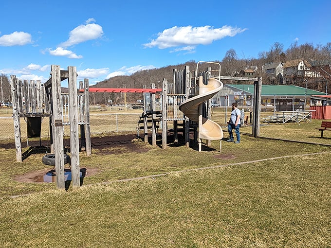 Old-school wooden playground equipment where kids still experience the radical concept of "playing outside" without a charging port in sight.