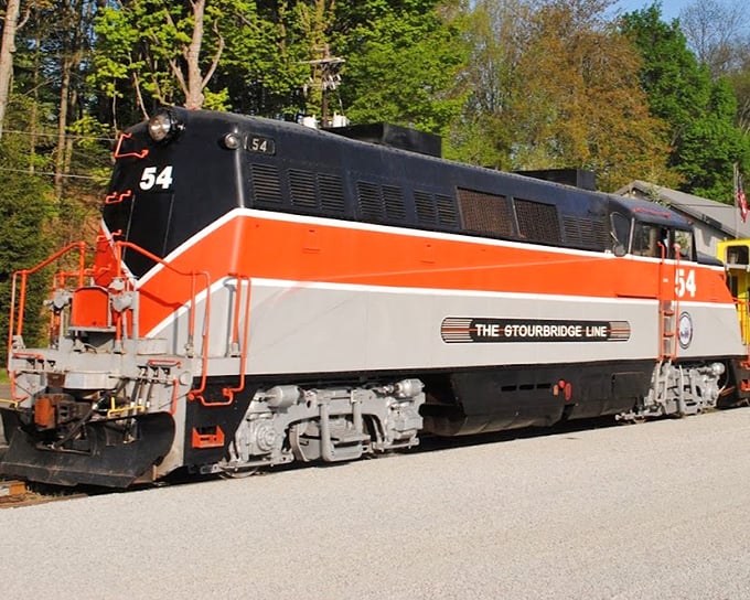 The "Horatio Alger" passenger car waits patiently, its burgundy exterior and wooden trim whispering stories of travelers past who gazed through these same windows.