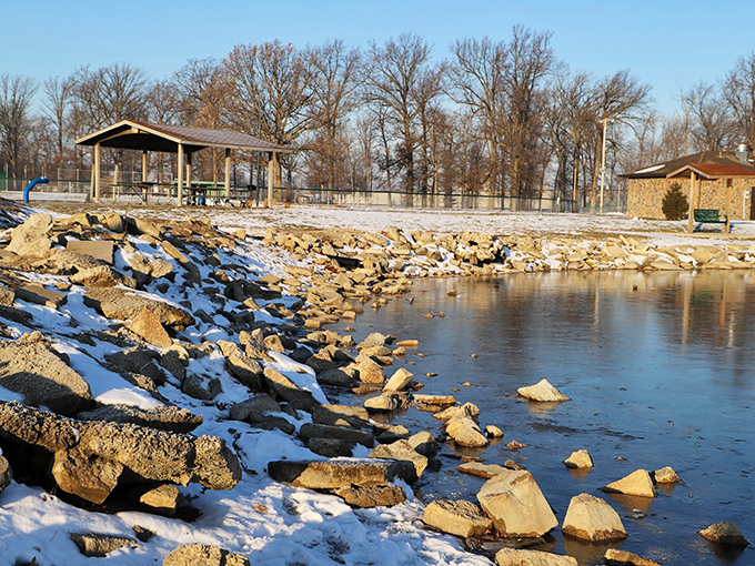 Winter transforms Eastview Park into a serene landscape where the lake's edge becomes a meditation spot for those brave enough to embrace the chill.