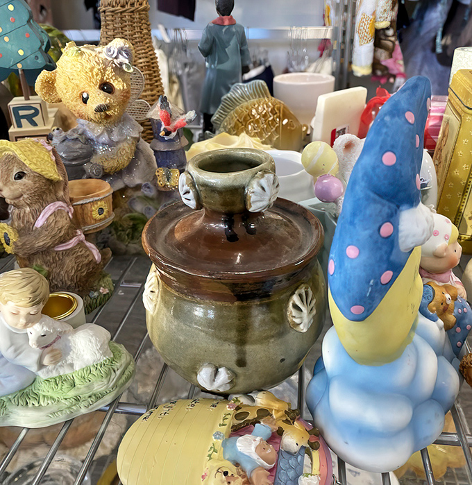 A miniature United Nations of knickknacks where ceramic creatures hold their eternal summit. That blue mushroom gnome definitely has the floor.