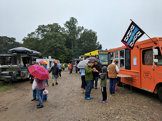 Rain or shine, the food truck armada stands ready. That bright orange truck isn't compensating—it's announcing its flavor confidence.