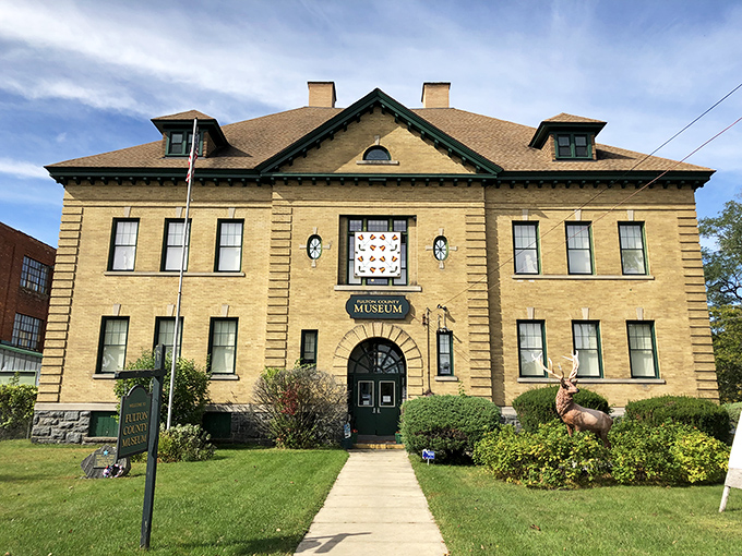 The Fulton County Museum's stately presence commands attention, a sandstone guardian preserving the area's rich glove-making legacy with unexpected charm.