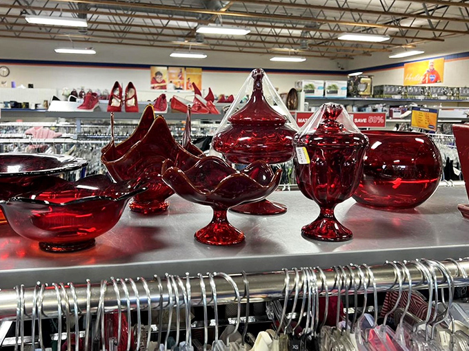 Ruby red glassware gleams under fluorescent lights like edible jewels, remnants of dinner parties and holiday gatherings seeking new tables.
