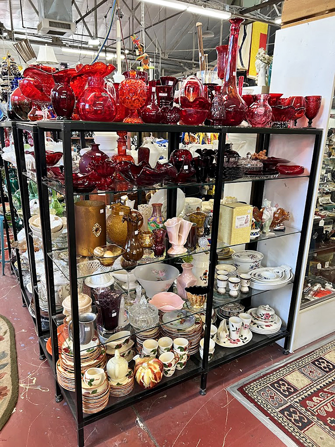 Ruby red glassware catches the light like liquid garnets, each piece telling stories of dinner parties past.